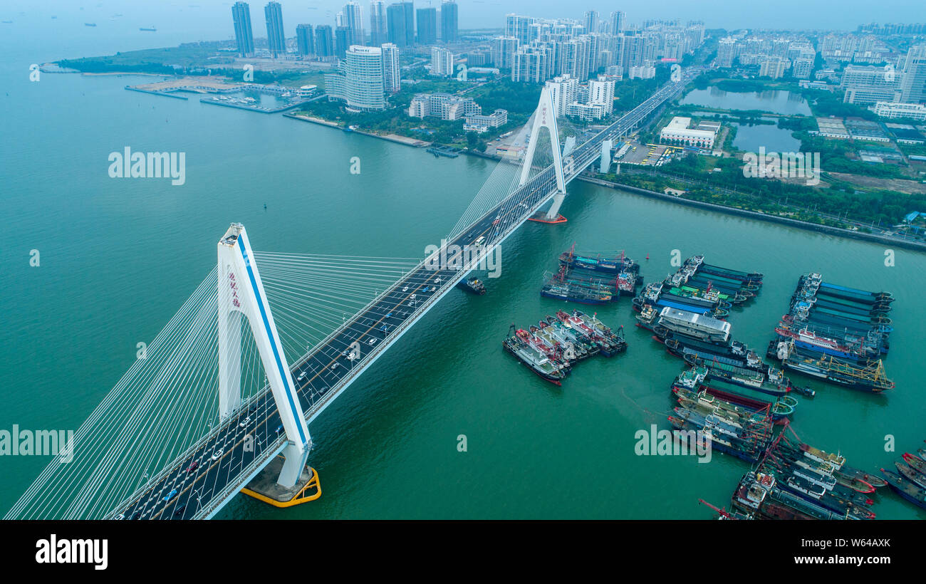 Fishing boats are docked at a harbor in preparation for Typhoon Barijat ...