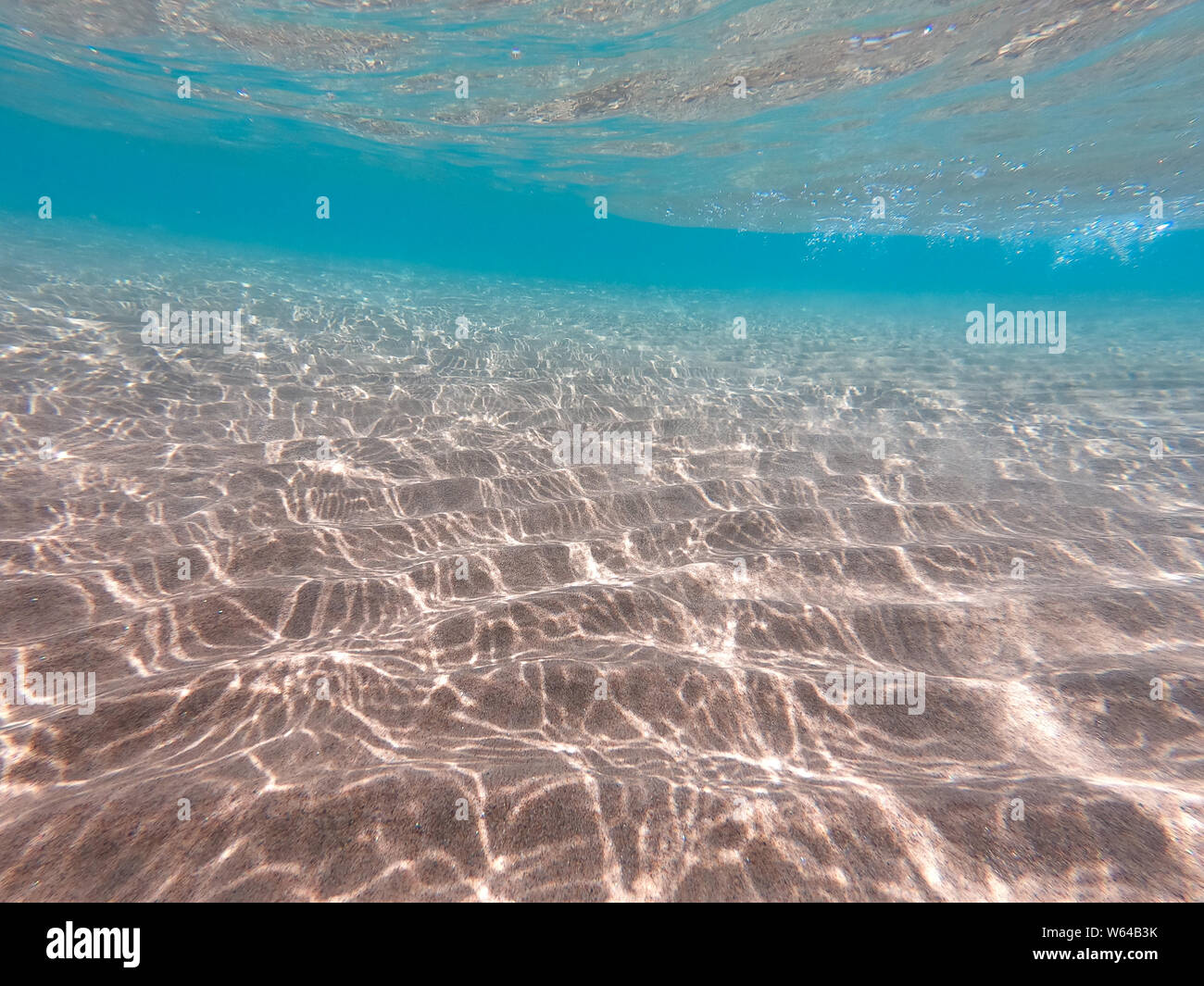 underwater background with sandy sea bottom. Beautiful texture of the ...