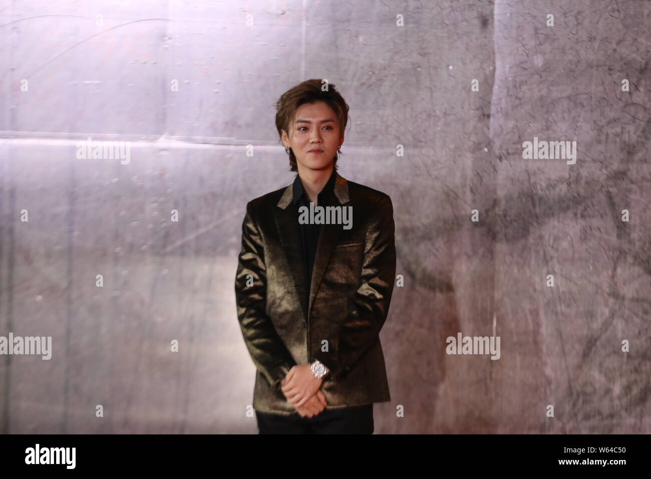 Chinese actor and singer Lu Han poses as he arrives on the red carpet ...