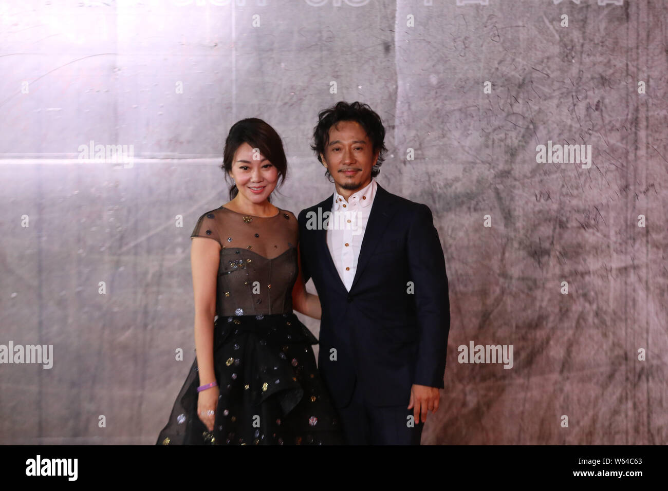 Chinese actress Yan Ni, left, and actor Zhao Lixin pose as they arrive on the red carpet for the ...