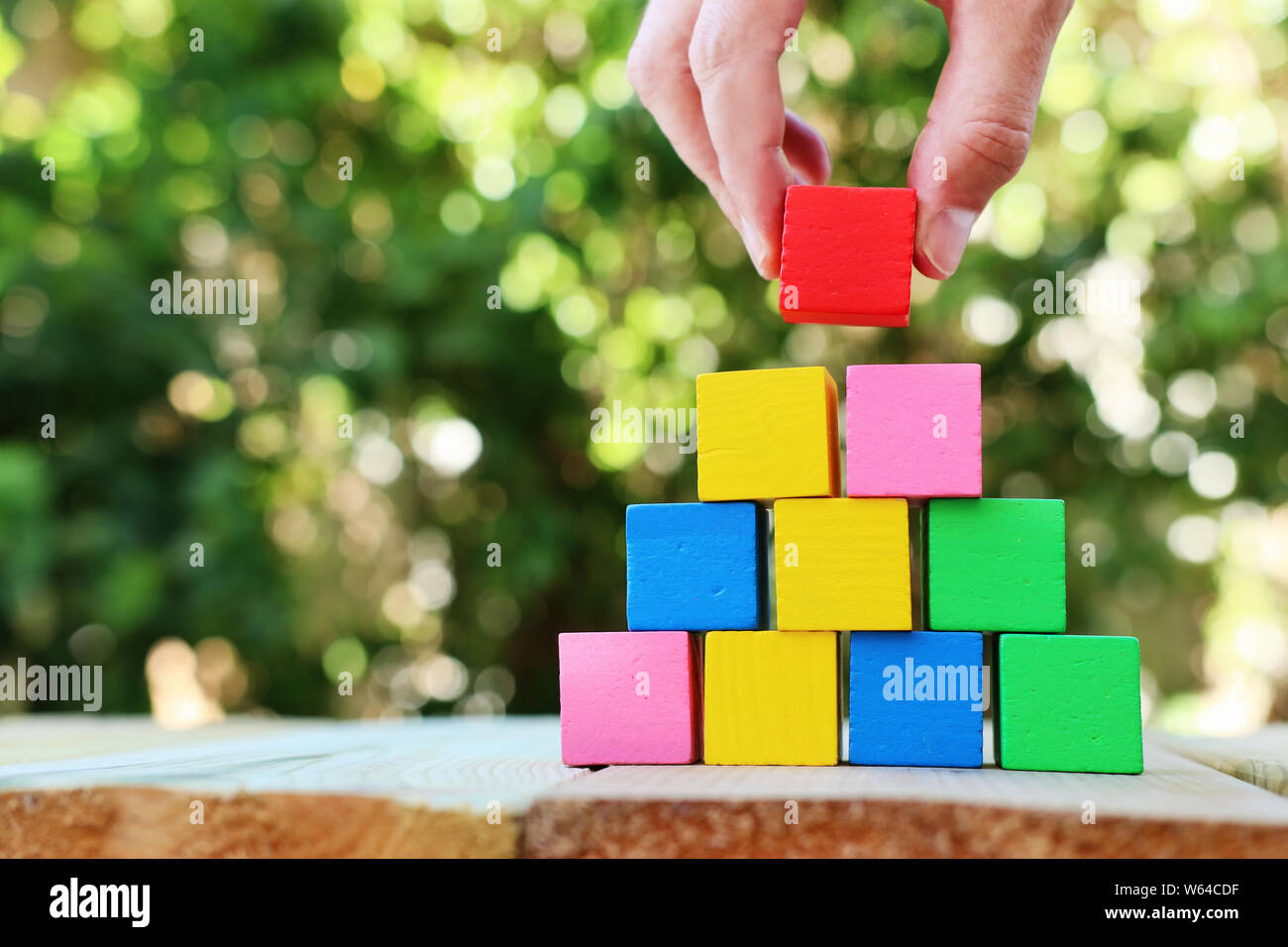 wood blocks stacking as step stairs. success and development concept ...