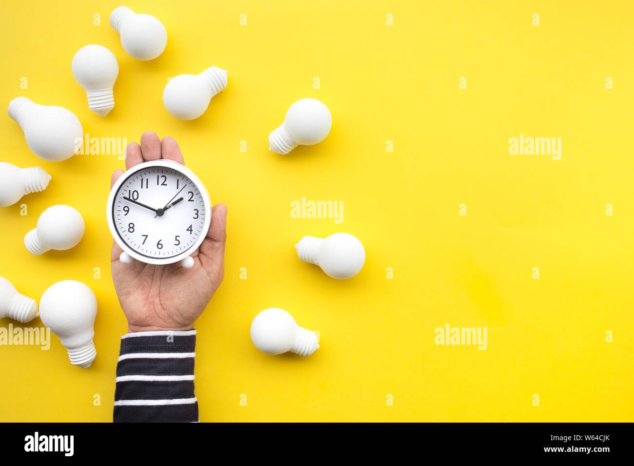 Time,dateline and creativity concepts with male hand holding clock with ...