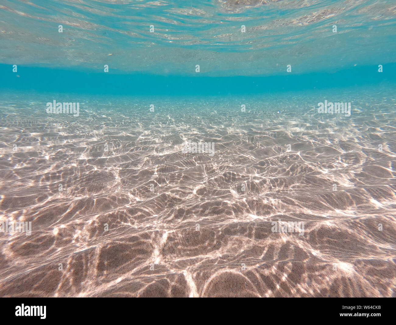 underwater background with sandy sea bottom. Beautiful texture of the ...