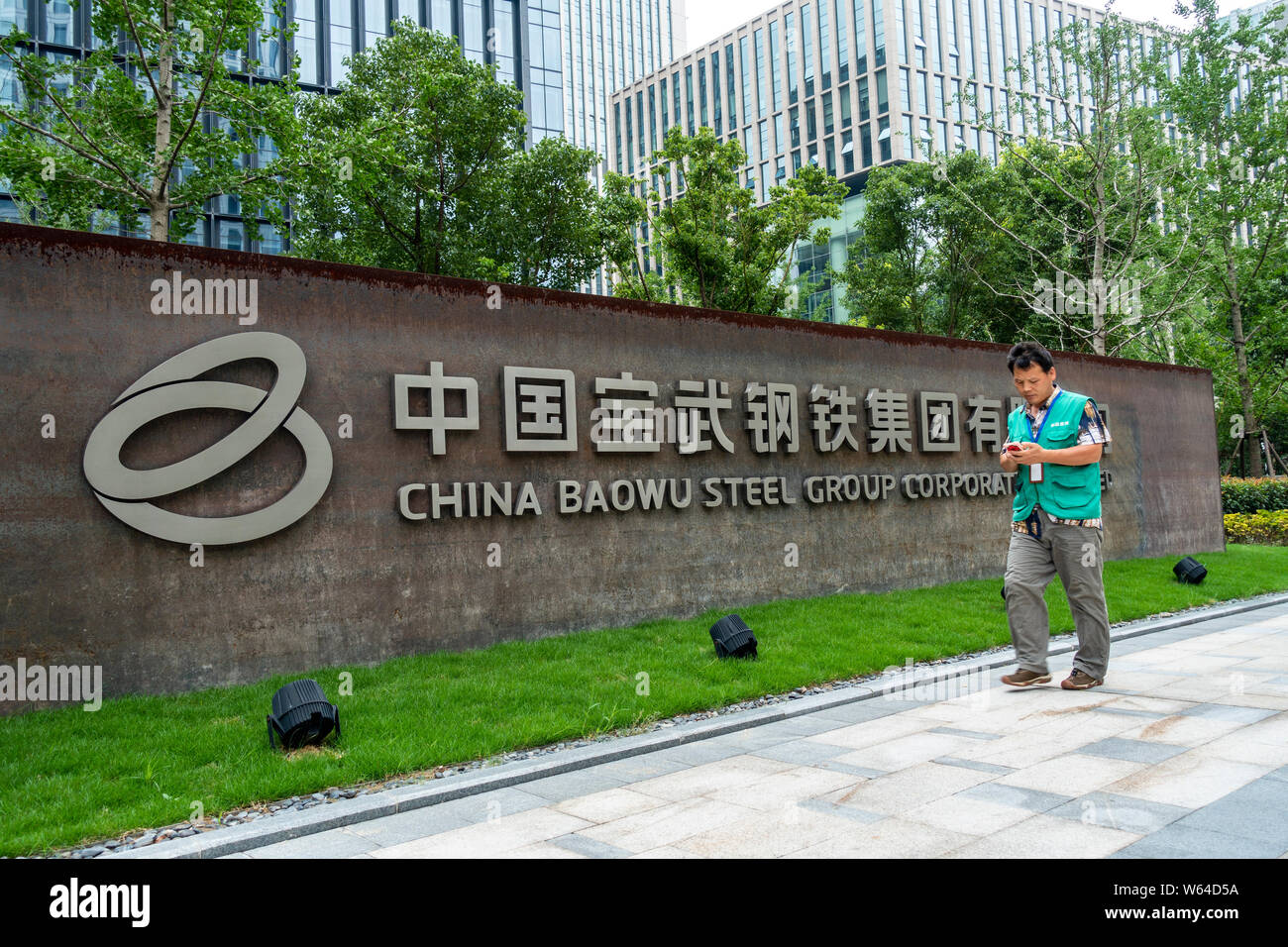 --FILE--A pedestrian walks past the headquarters of Baowu Steel Group ...