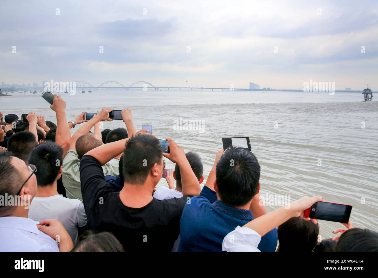 Visitors and local residents watch waves from one-line tidal bore of ...