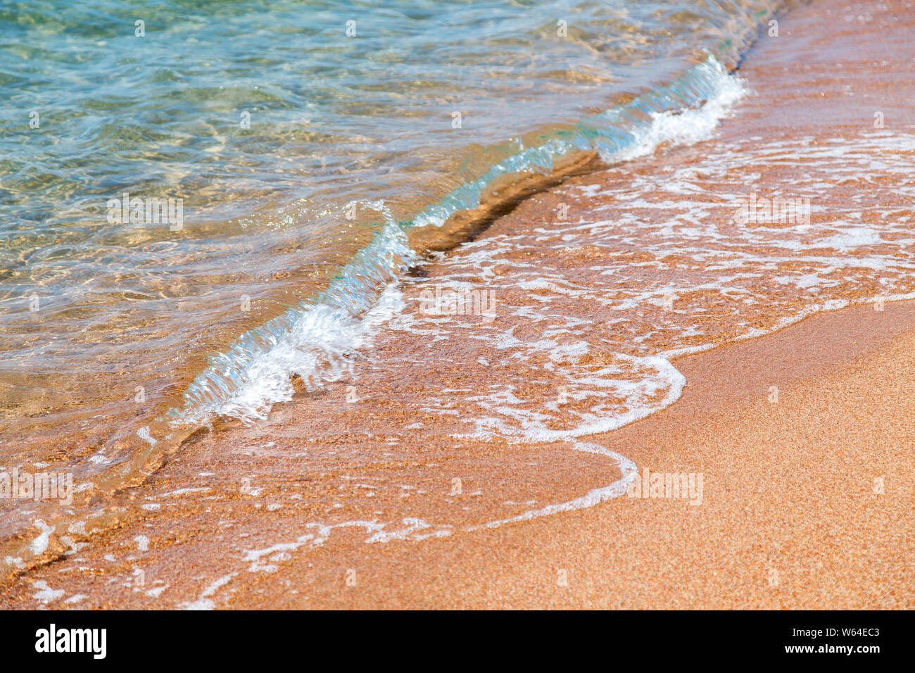 Sea shore. Blue transparent water and sand Stock Photo - Alamy