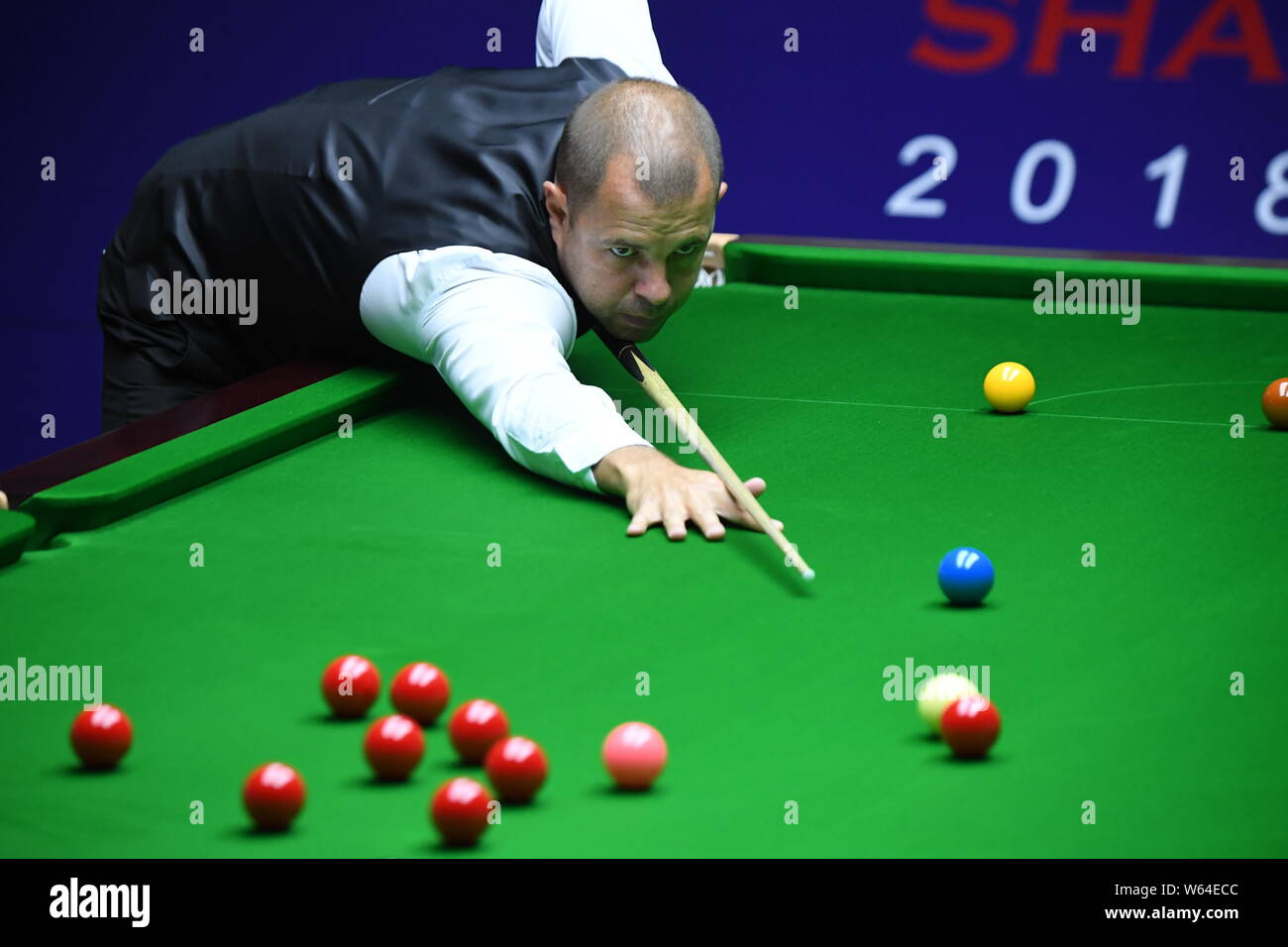 Barry Hawkins of England plays a shot to Ding Junhui of China in their ...