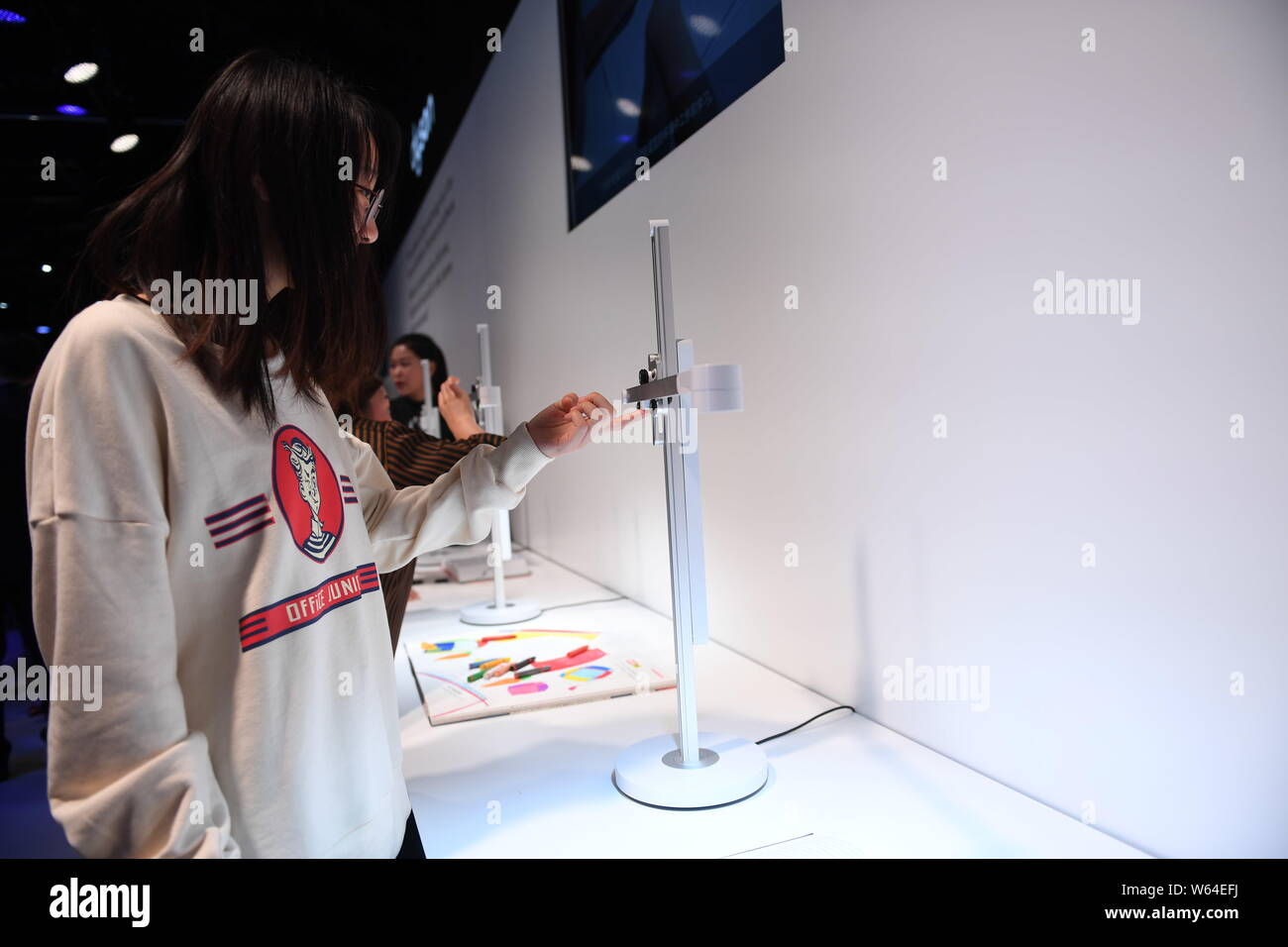 A visitor looks at a Dyson Lightcycle? lamp on display at Dyson's new ...