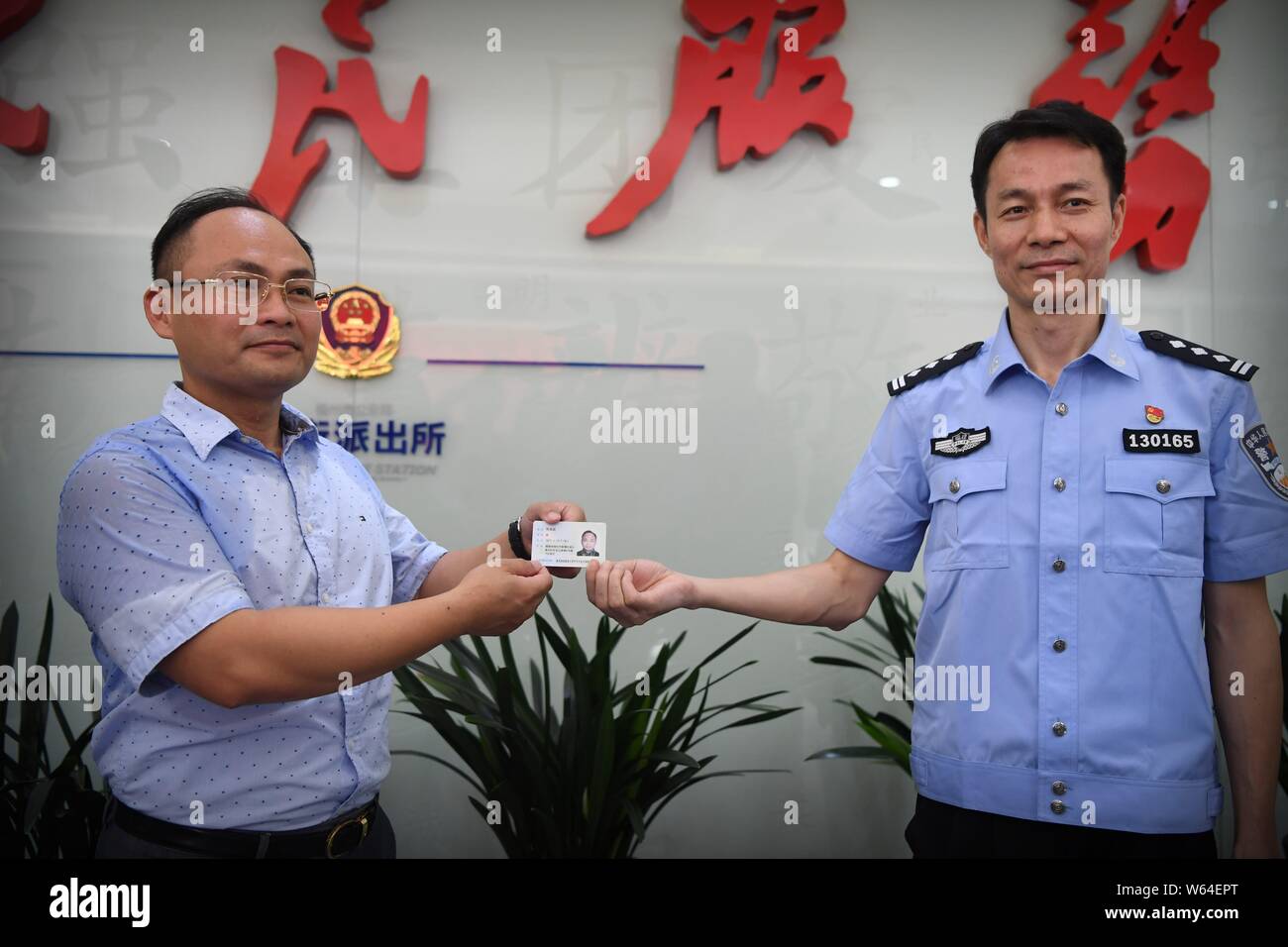A Taiwan resident living in the Chinese mainland displays the residence ...