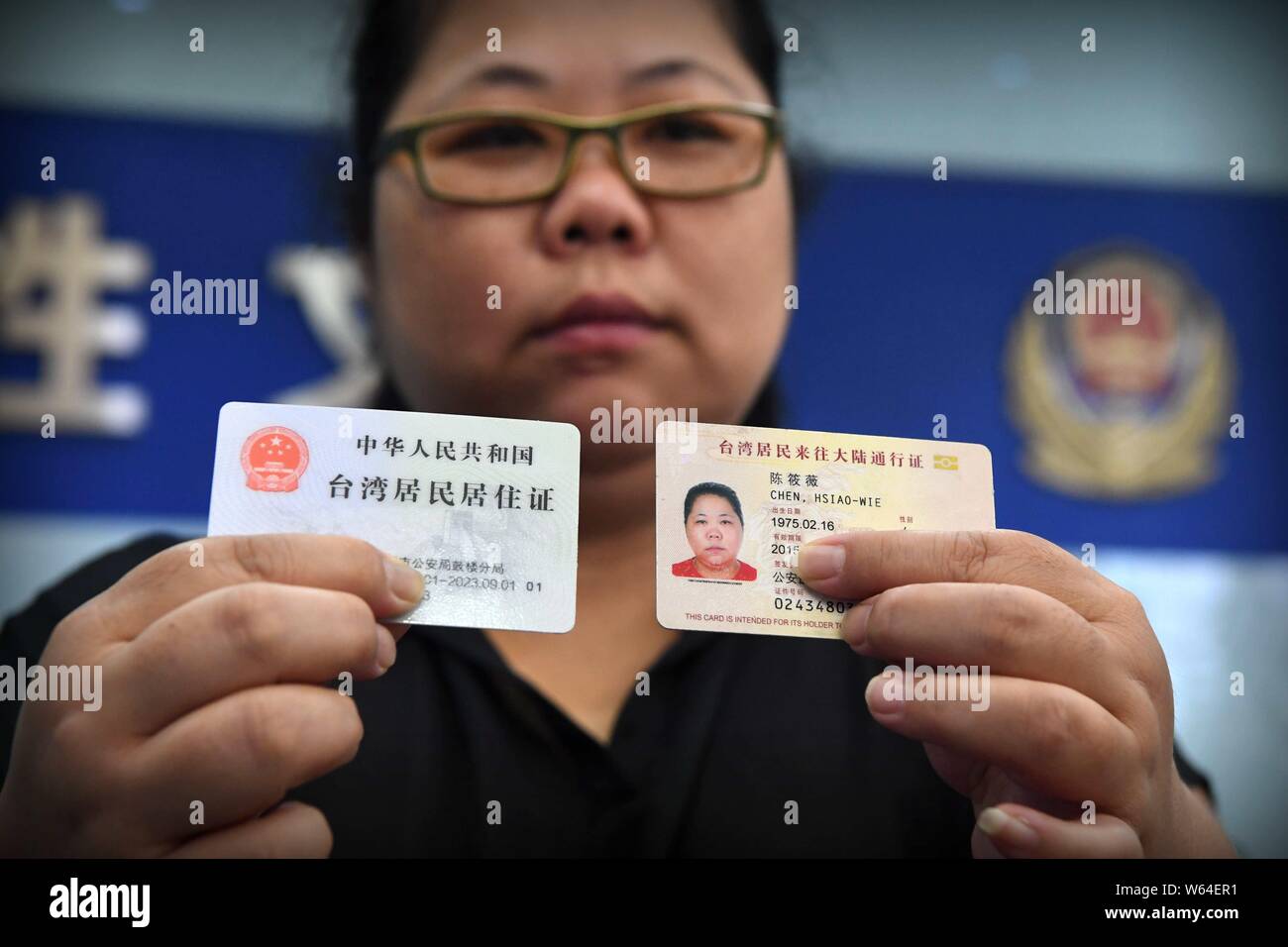 A Taiwan resident living in the Chinese mainland displays the residence ...