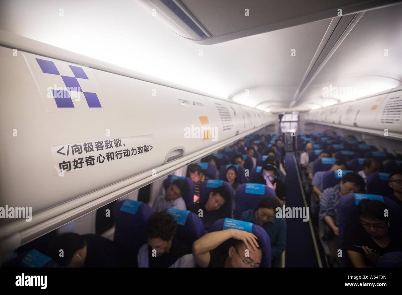 Chinese passengers are seen onboard Flight CZ6163 from Beijing to ...