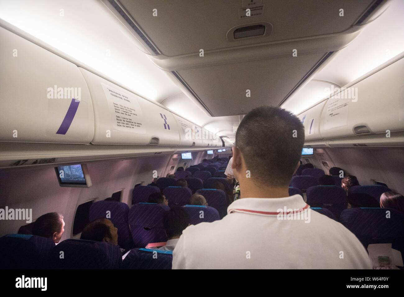 Chinese passengers are seen onboard Flight CZ6163 from Beijing to ...