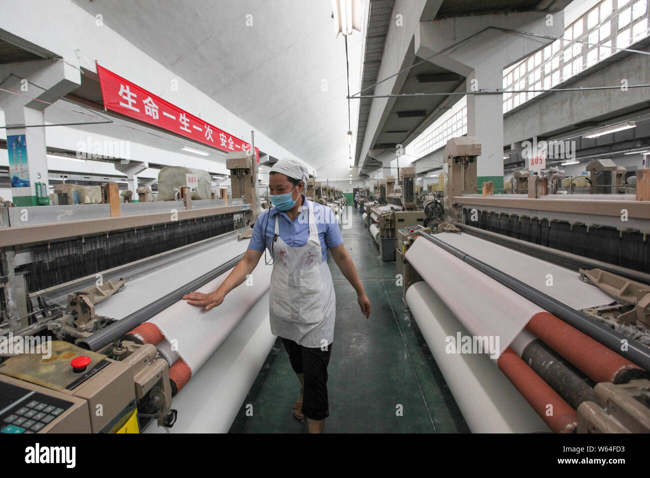 --FILE--A female Chinese worker handles production of yarn at a textile factory in Nanping city ...