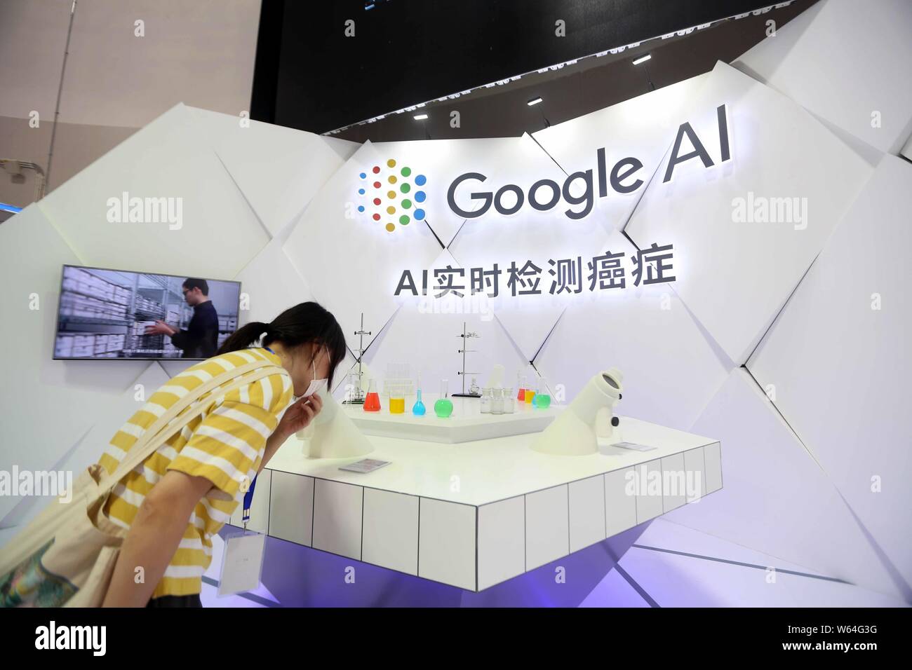 A visitor is seen at the booth for Google's AI technology demonstrates ...