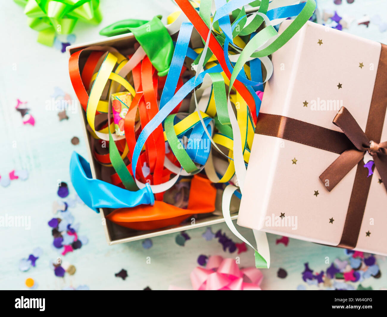 Open gift box with streamers, confetti. Party concept Stock Photo - Alamy