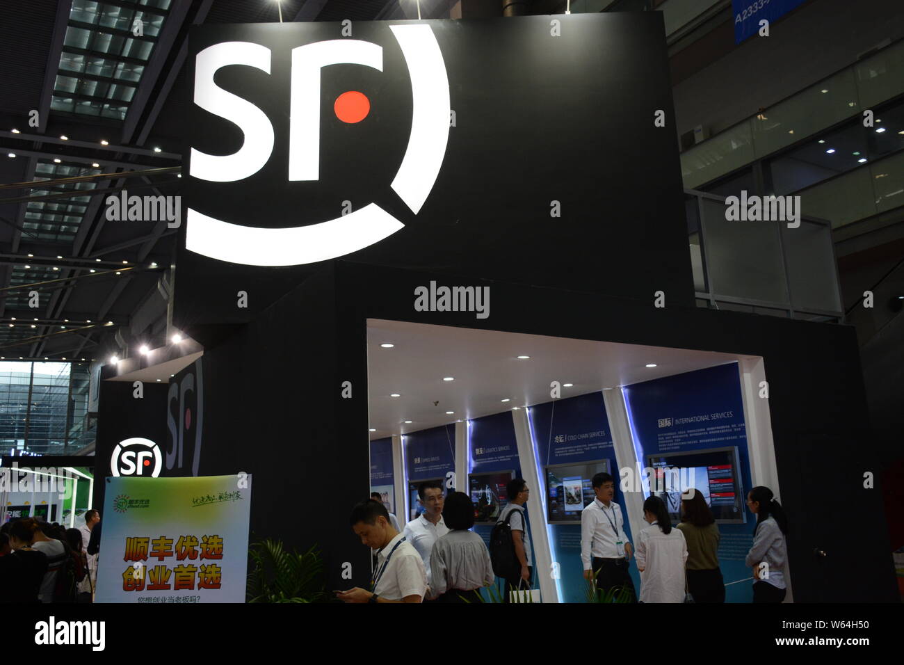 --FILE--People visit the stand of SF Express during an expo in Shenzhen ...