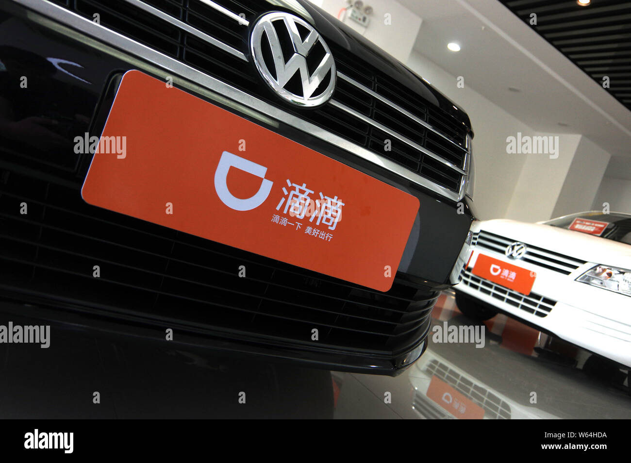 --FILE--A signboard of taxi-hailing and car service Didi Chuxing is ...