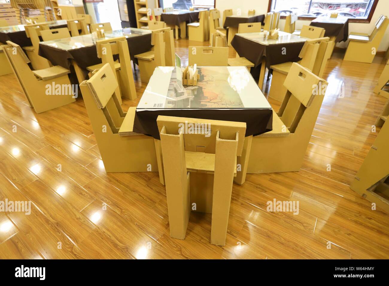 The corrugated fiberboard-made tables and chairs are displayed at the ...