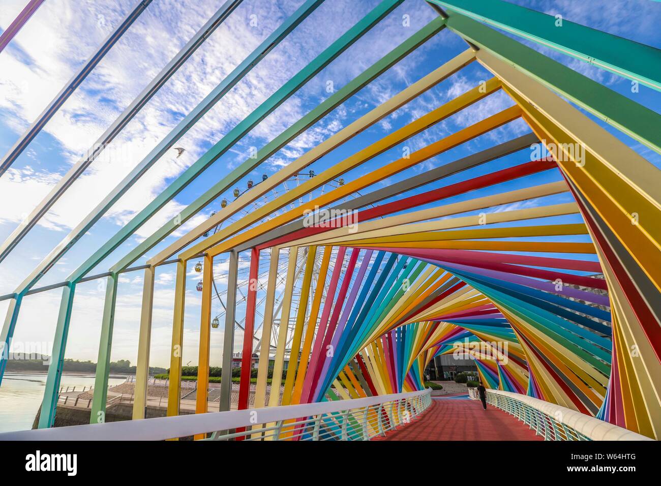 A pedestrian walks on the "Qicai bridge", which means bridge of seven ...