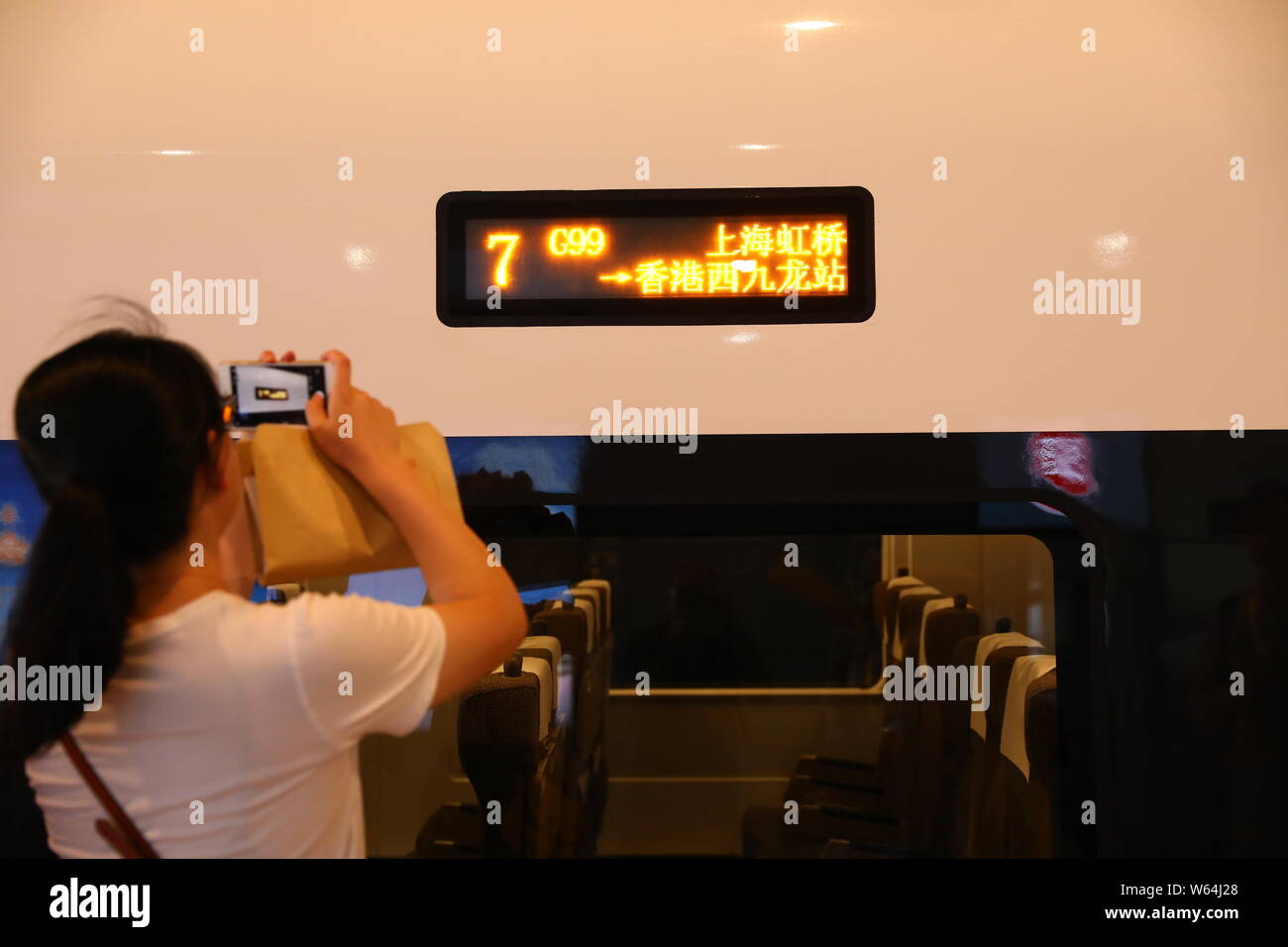 Passengers of train G99, the first high-speed train from Shanghai to ...