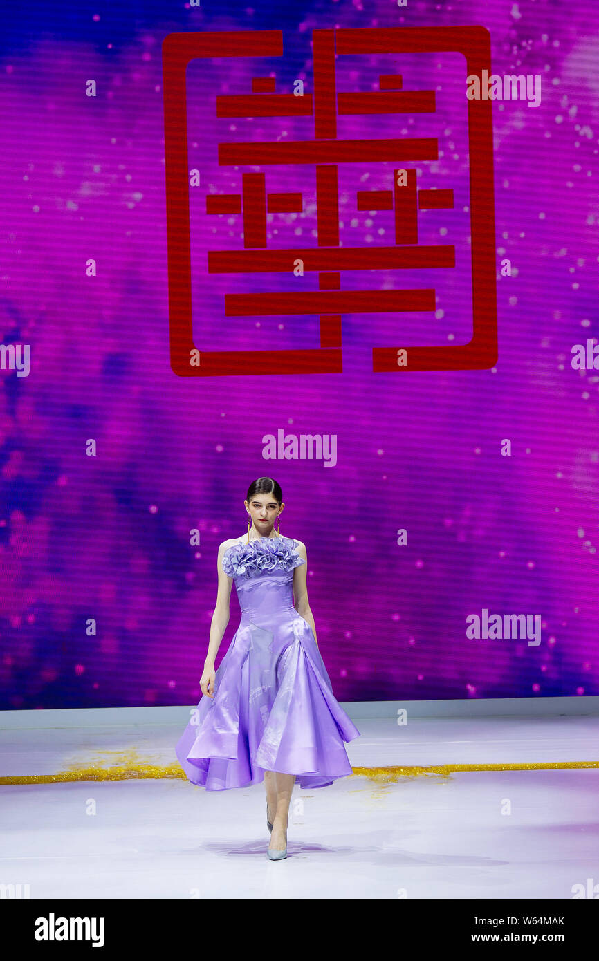 A model displays a traditional new creation at a fashion show during ...