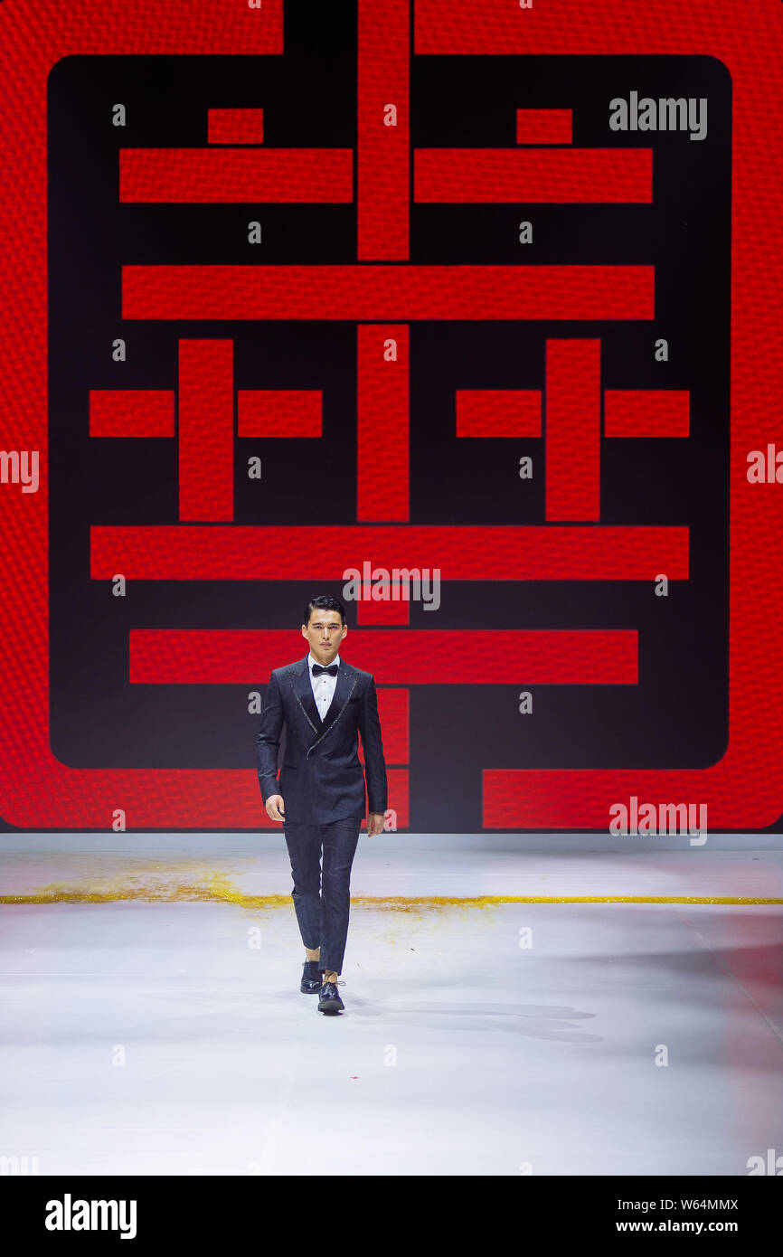 A model displays a traditional new creation at a fashion show during ...