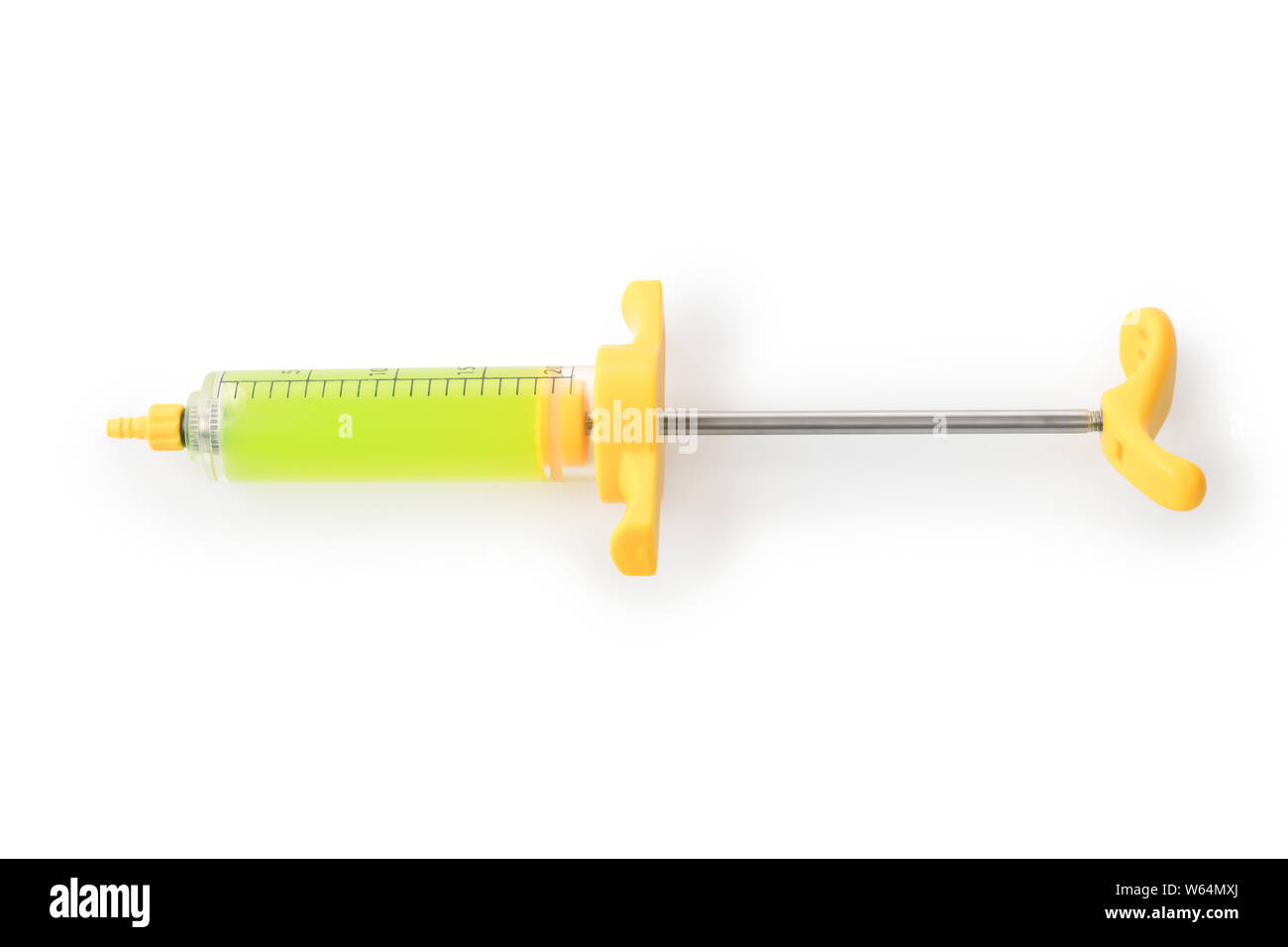 Large yellow technical syringe with green substance. Isolated on white ...