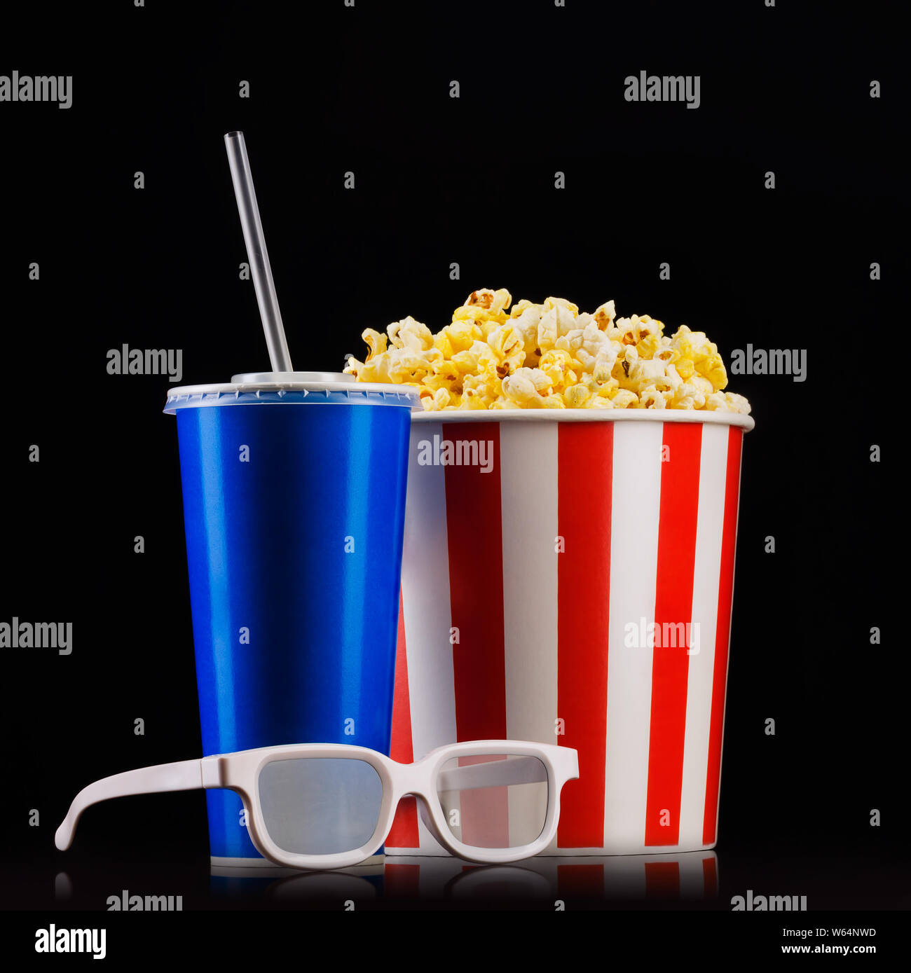 Paper striped bucket with popcorn, cup of soft drink and glasses ...