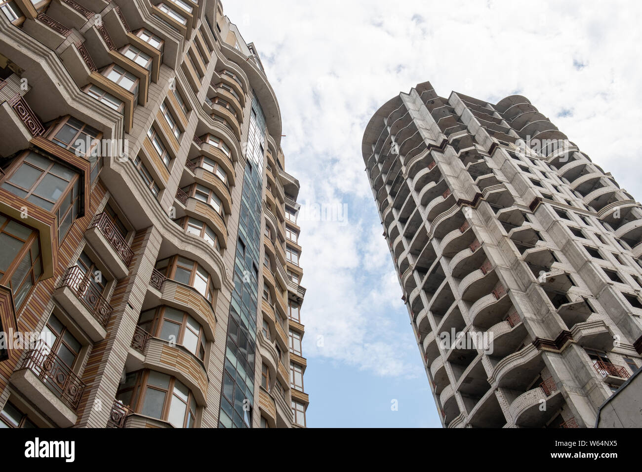 Bottom view of residential buildings with blue sky. Frame. Bottom view ...