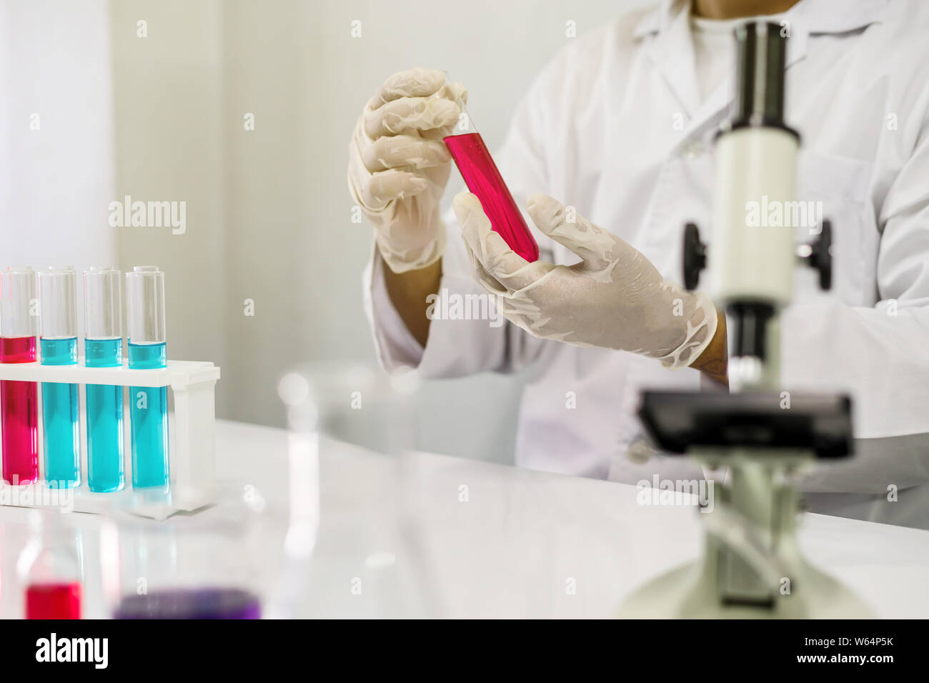 Scientist with equipment working at laboratory with test tubes Stock ...