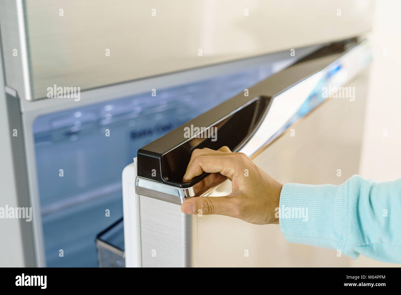 Hand opening refrigerator hi-res stock photography and images - Alamy