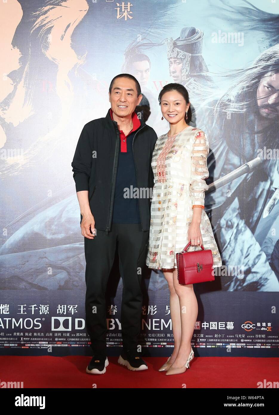 Chinese director Zhang Yimou, left, and his wife Chen Ting arrive on ...