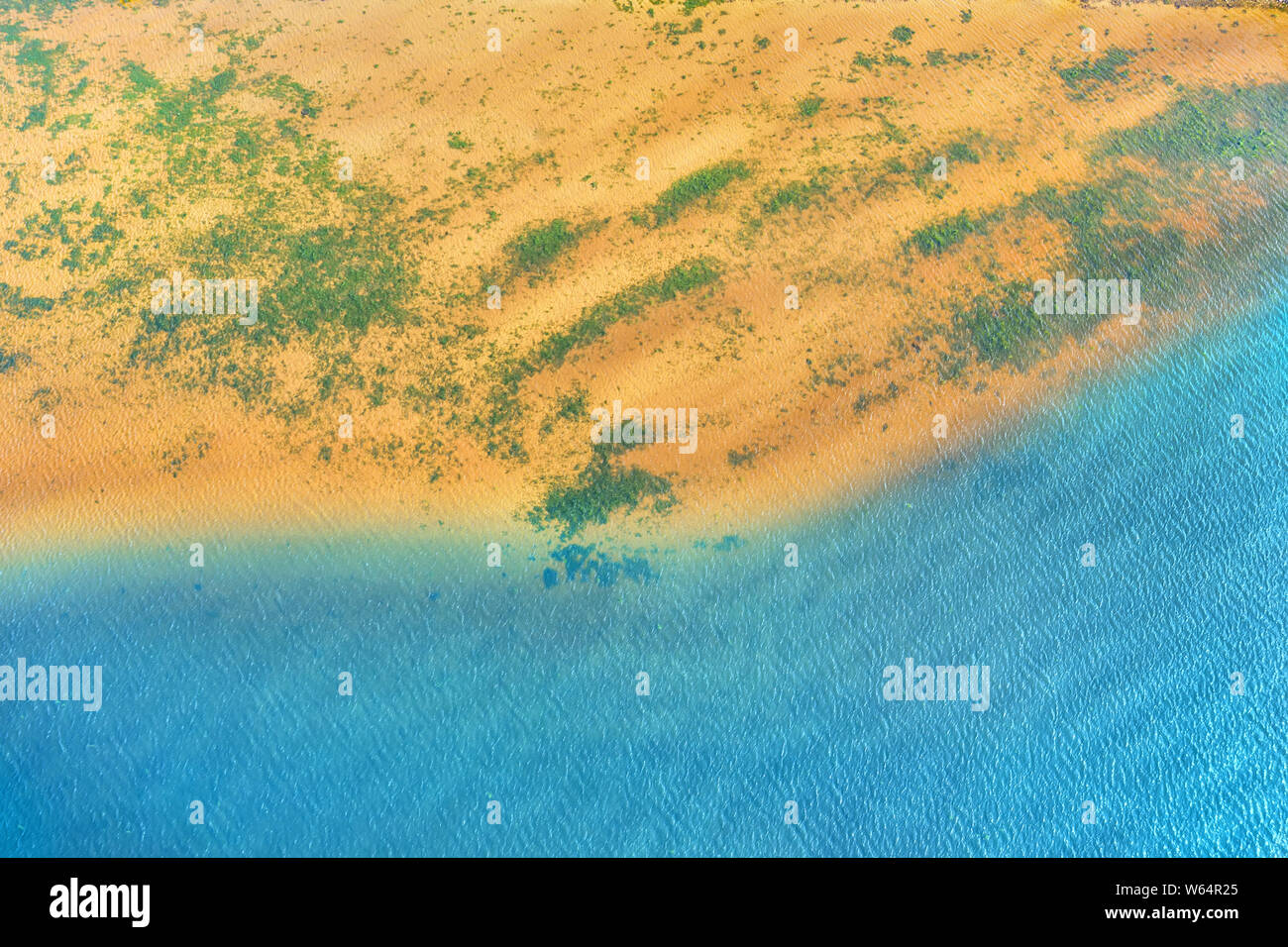 Shallow with sandy bottom and ocean ripple aerial view. Natural texture ...