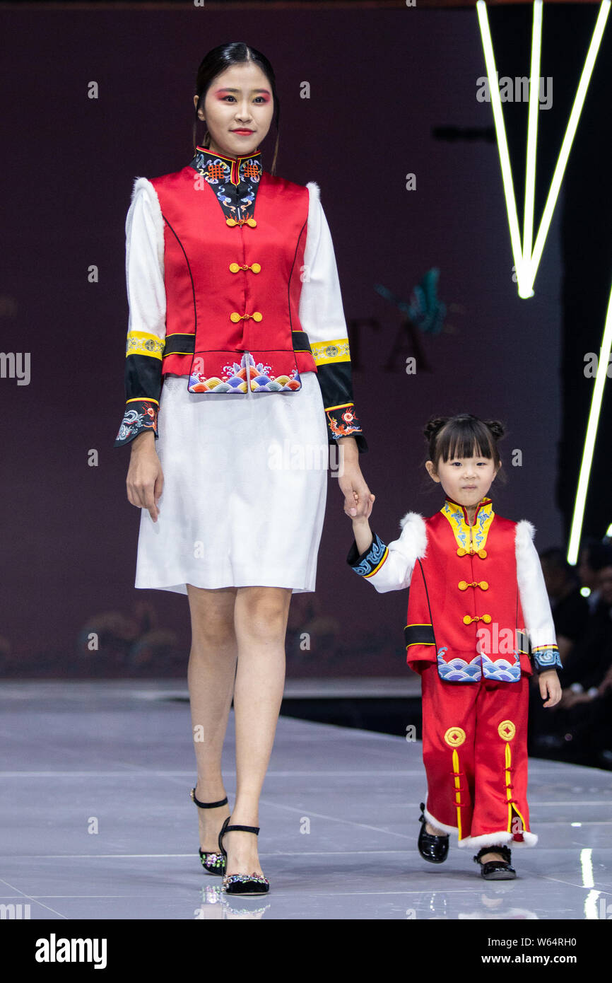 Models display traditional new creations during the China Intangible ...
