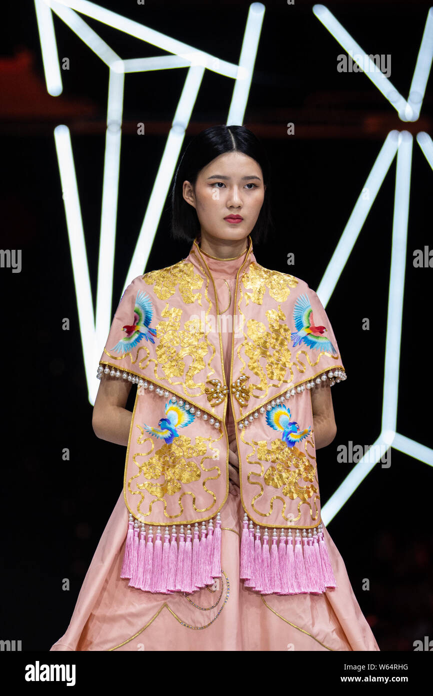 A model displays a traditional new creation during the China Intangible ...