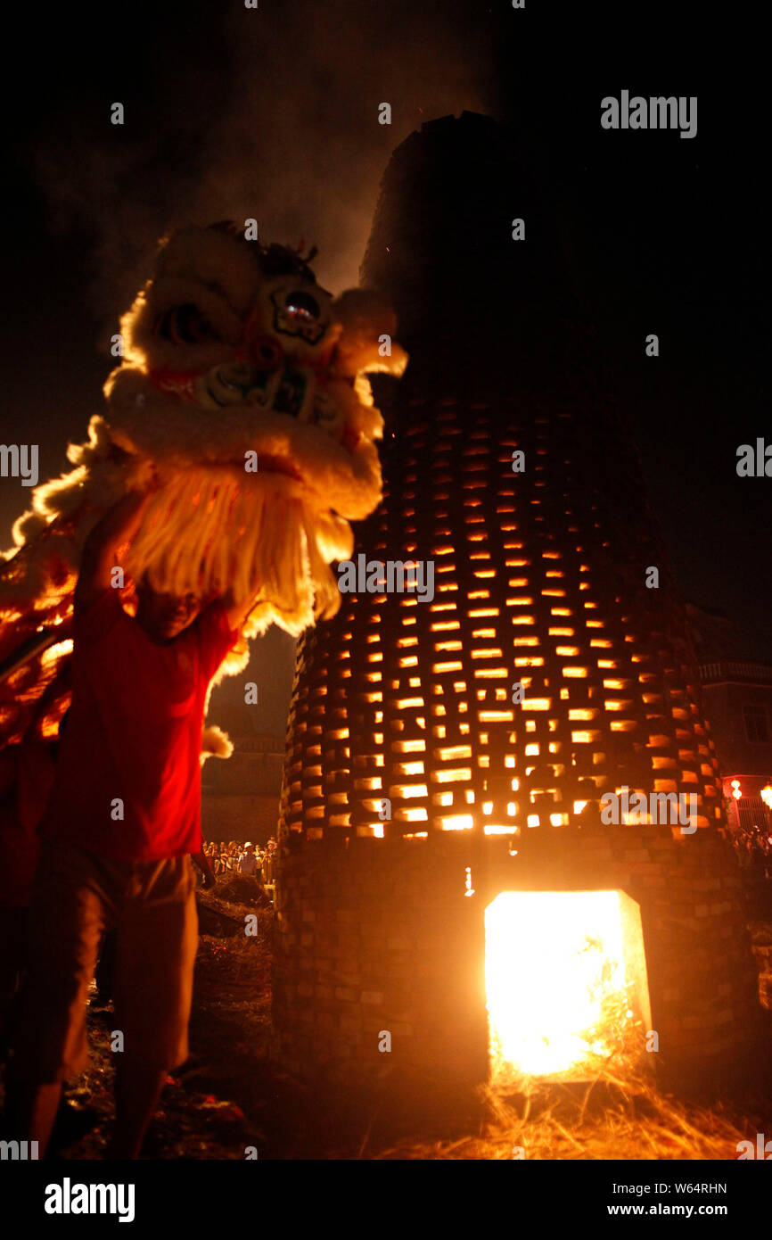 A pagoda made of tile bricks is on fire to mark the Mid-Autumn Festival ...