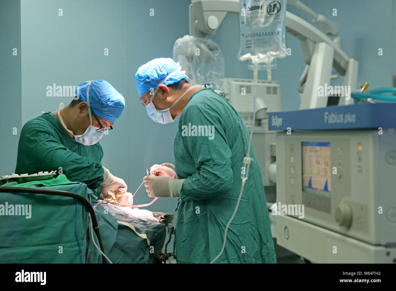 Chinese doctors have an operation on a patient at a hospital in ...