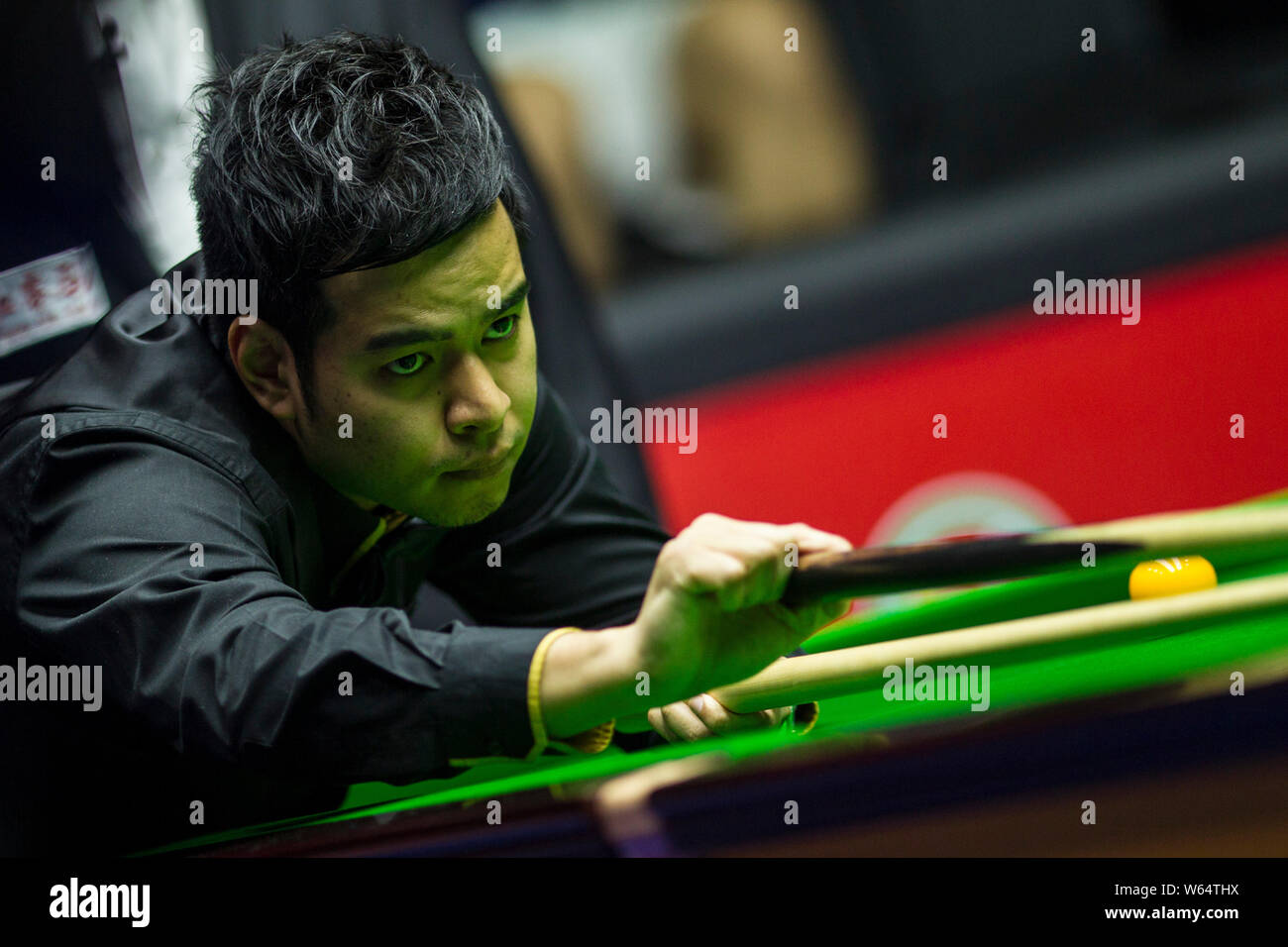 Noppon Saengkham of Thailand plays a shot to Mark Williams of Wales in ...