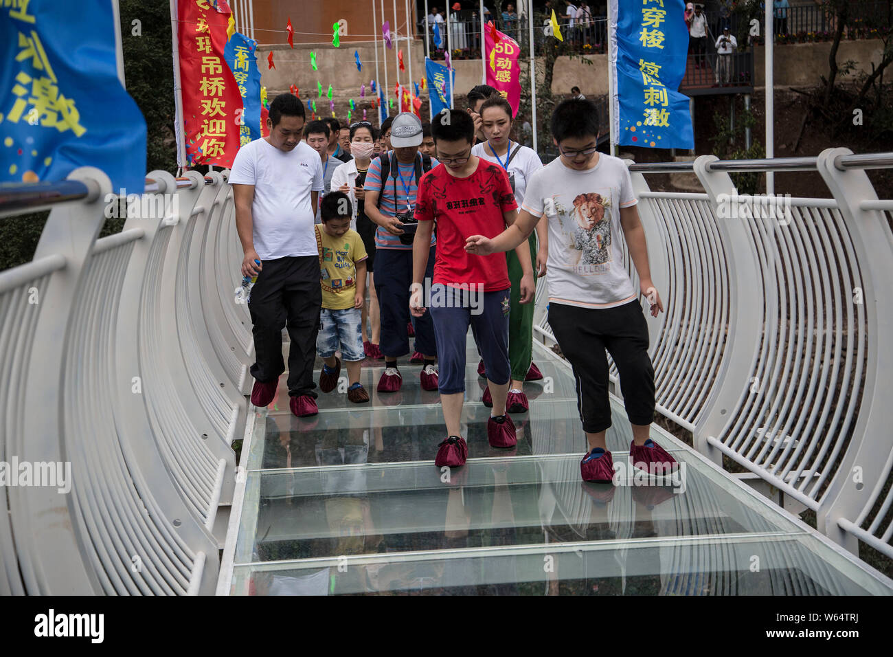 Tourists brave the 5D glass-bottom bridge over the Qinglong Valley in ...