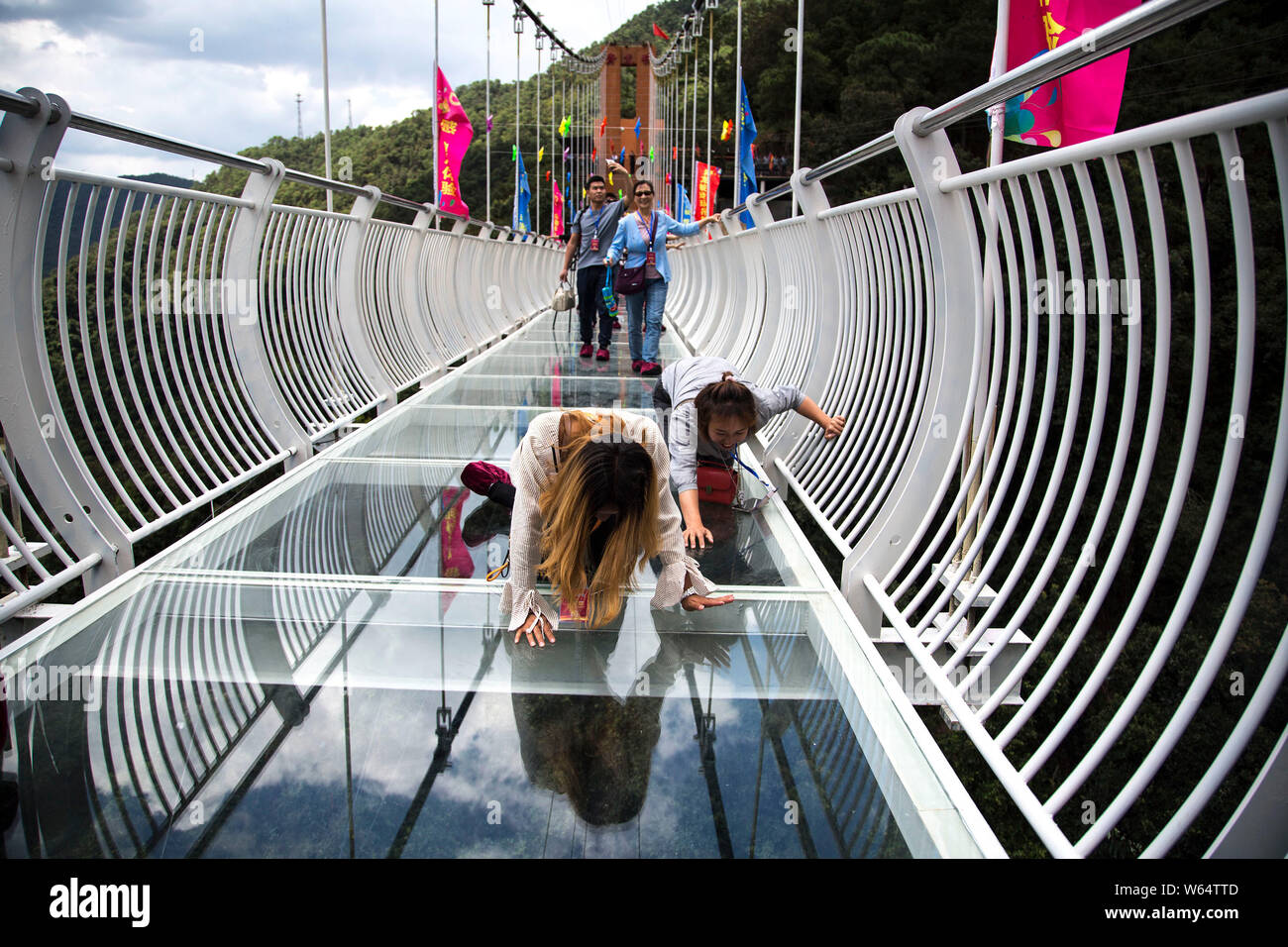 Tourists brave the 5D glass-bottom bridge over the Qinglong Valley in ...
