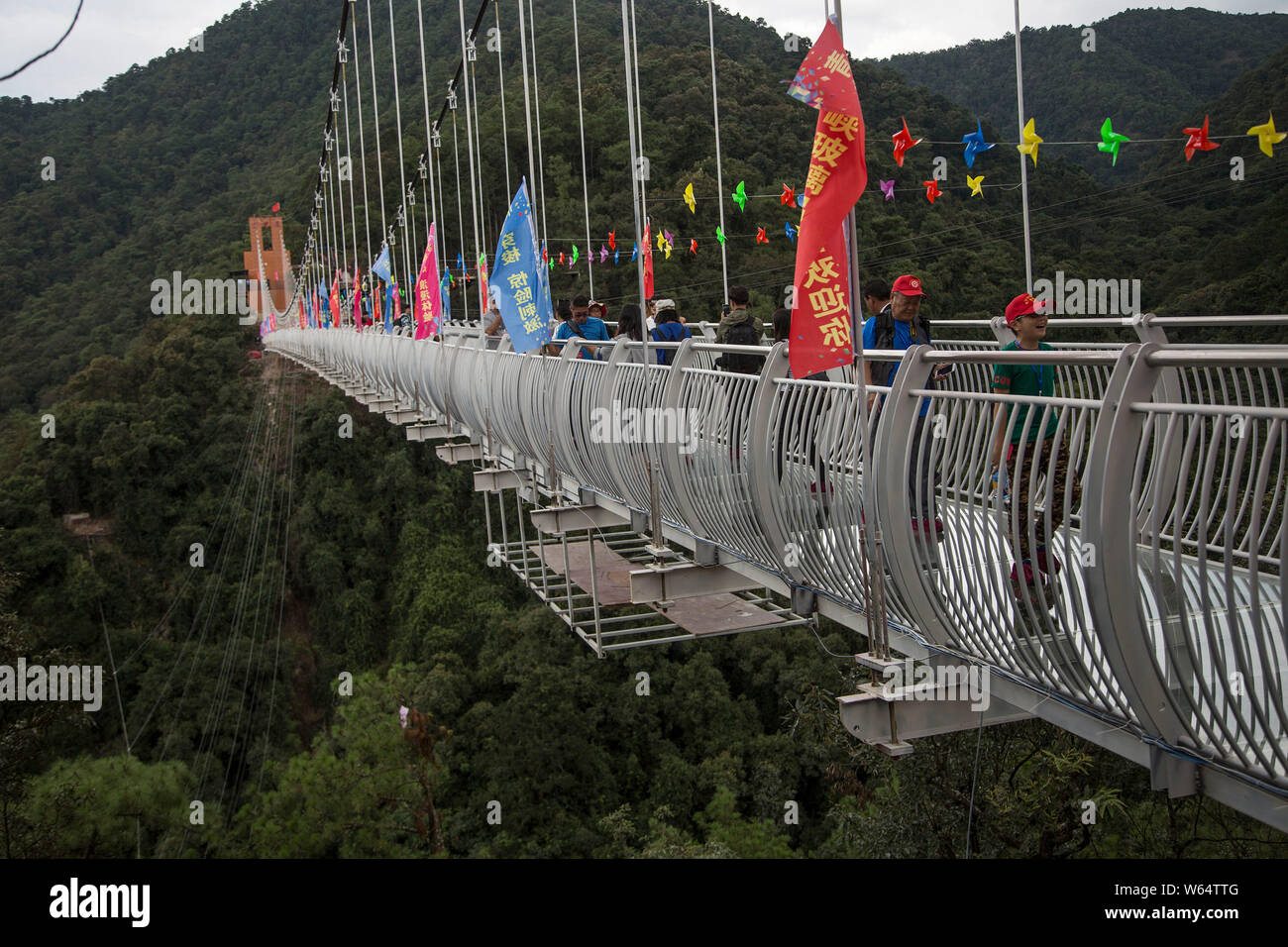 Tourists brave the 5D glass-bottom bridge over the Qinglong Valley in ...