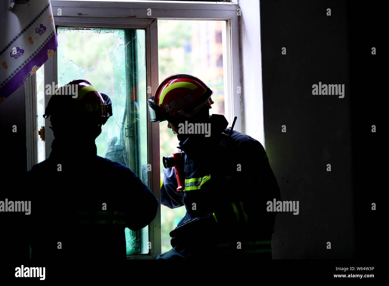 Chinese firefighters demolish a broken window after a liquefied gas ...