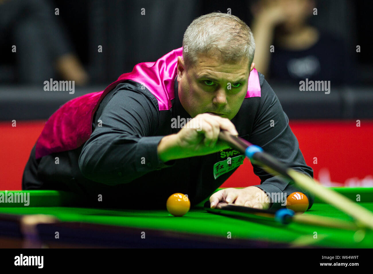 Robert Milkins of England plays a shot to Marco Fu of Hong Kong in ...