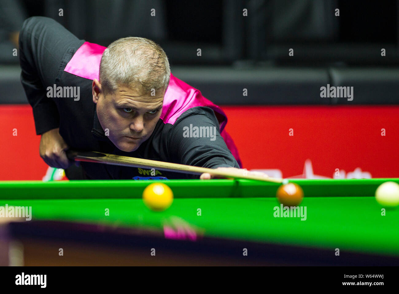 Robert Milkins of England plays a shot to Marco Fu of Hong Kong in ...