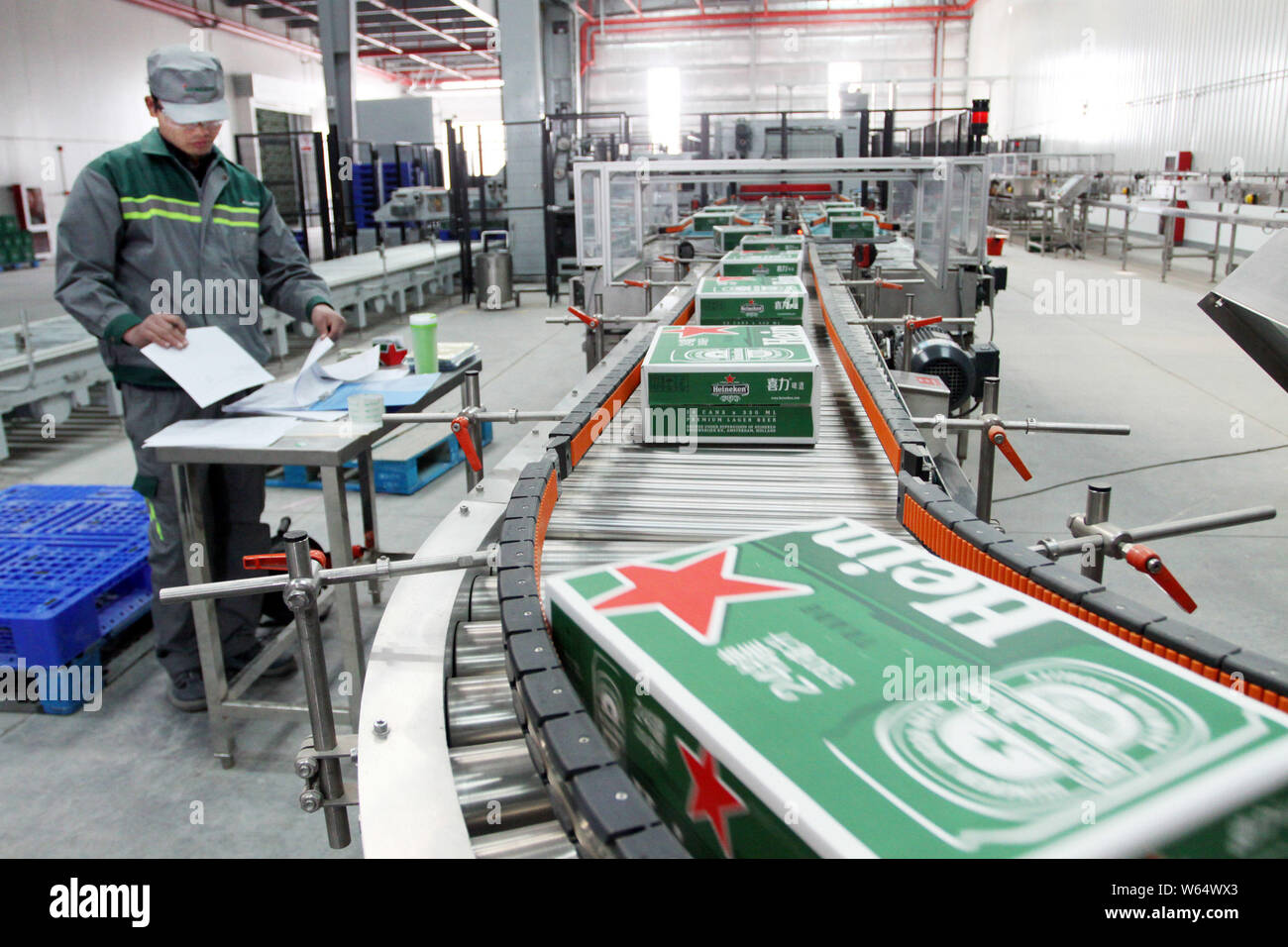 --FILE--Cartons of Heineken beer are being produced on the assembly ...