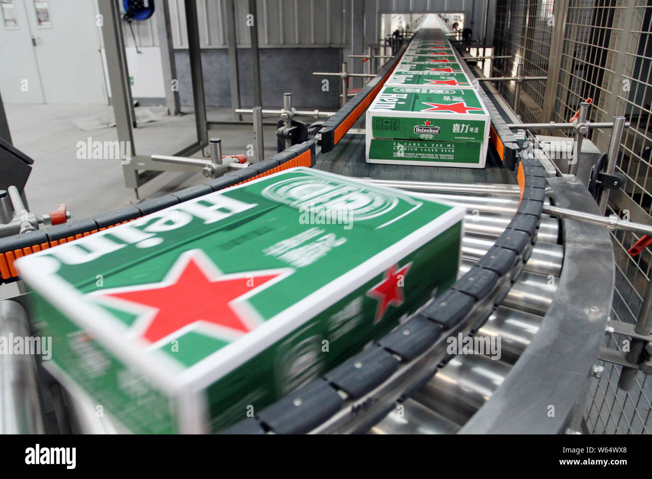 --FILE--Cartons of Heineken beer are being produced on the assembly ...