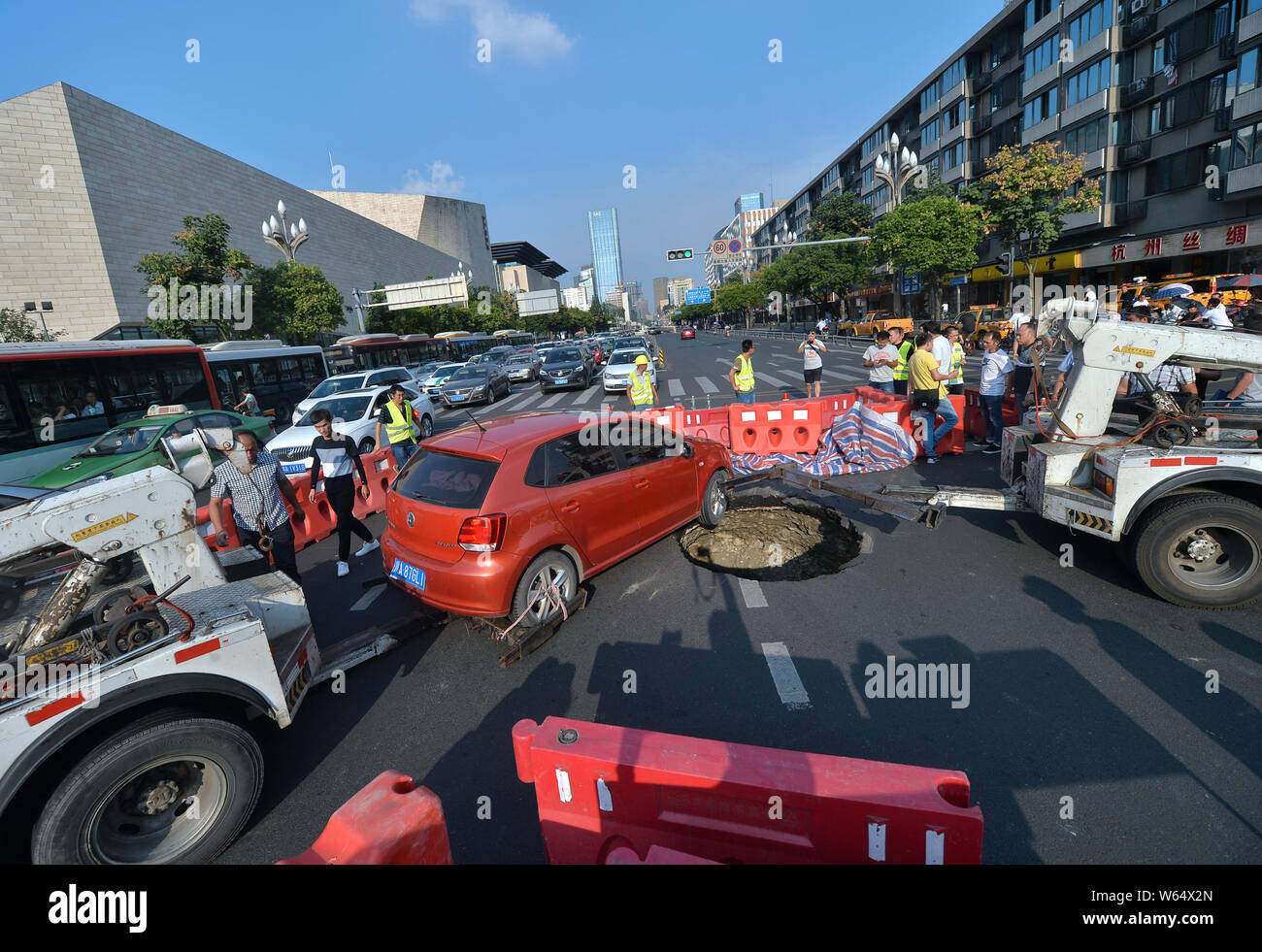 A vehicle is trapped in a sinkhole after a road collapse in Chengdu ...