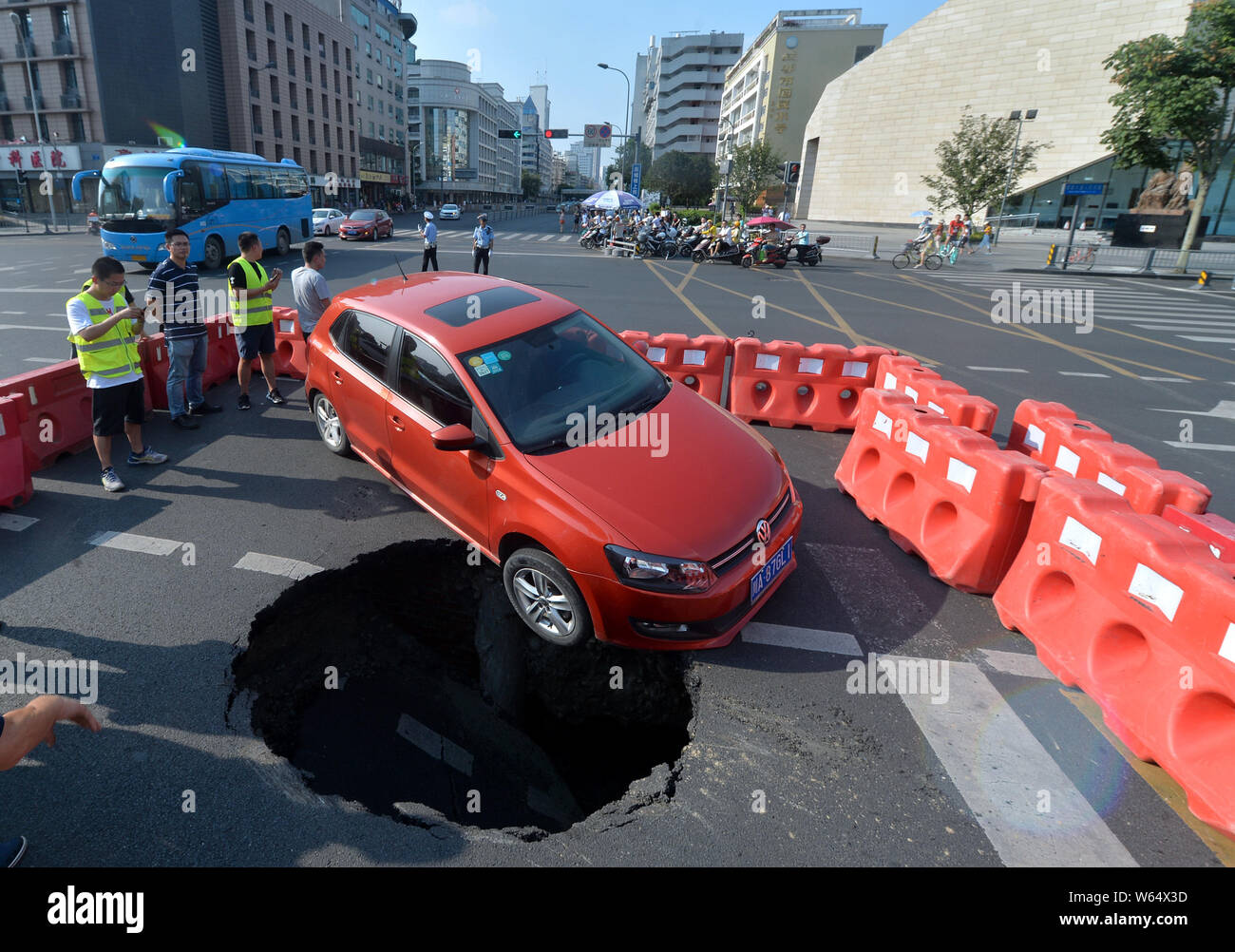A vehicle is trapped in a sinkhole after a road collapse in Chengdu ...