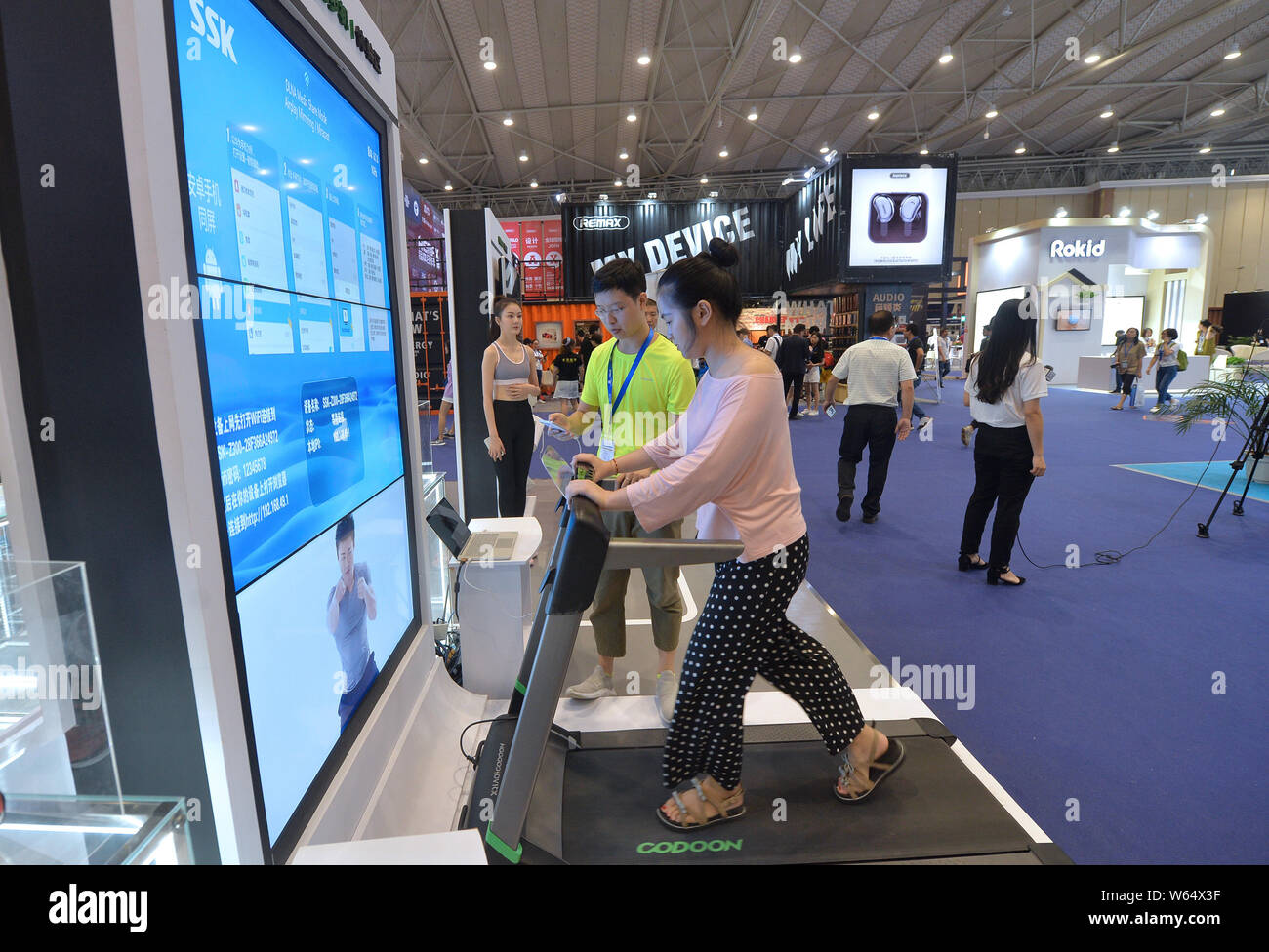 --FILE--A visitor tries out a running machine at the stand of online ...