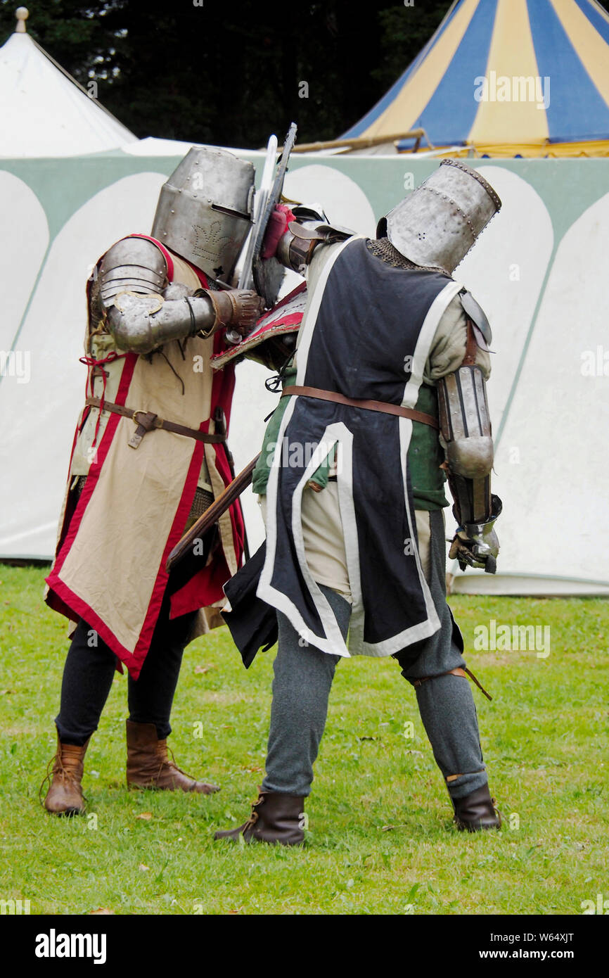 Military re-enactors demonstrate the armour and one on one sword ...